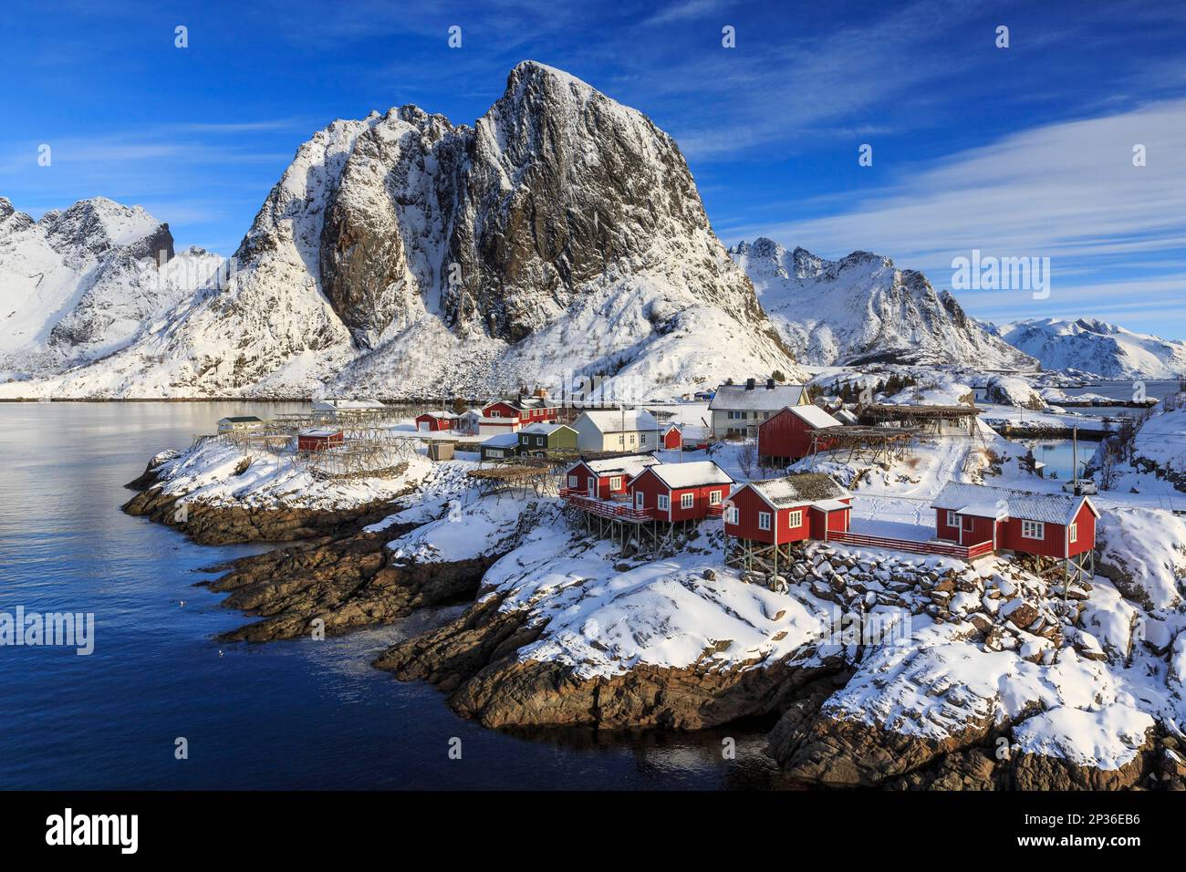 Red rorbuer in winter, fishermens cabins, snow-covered mountain ...