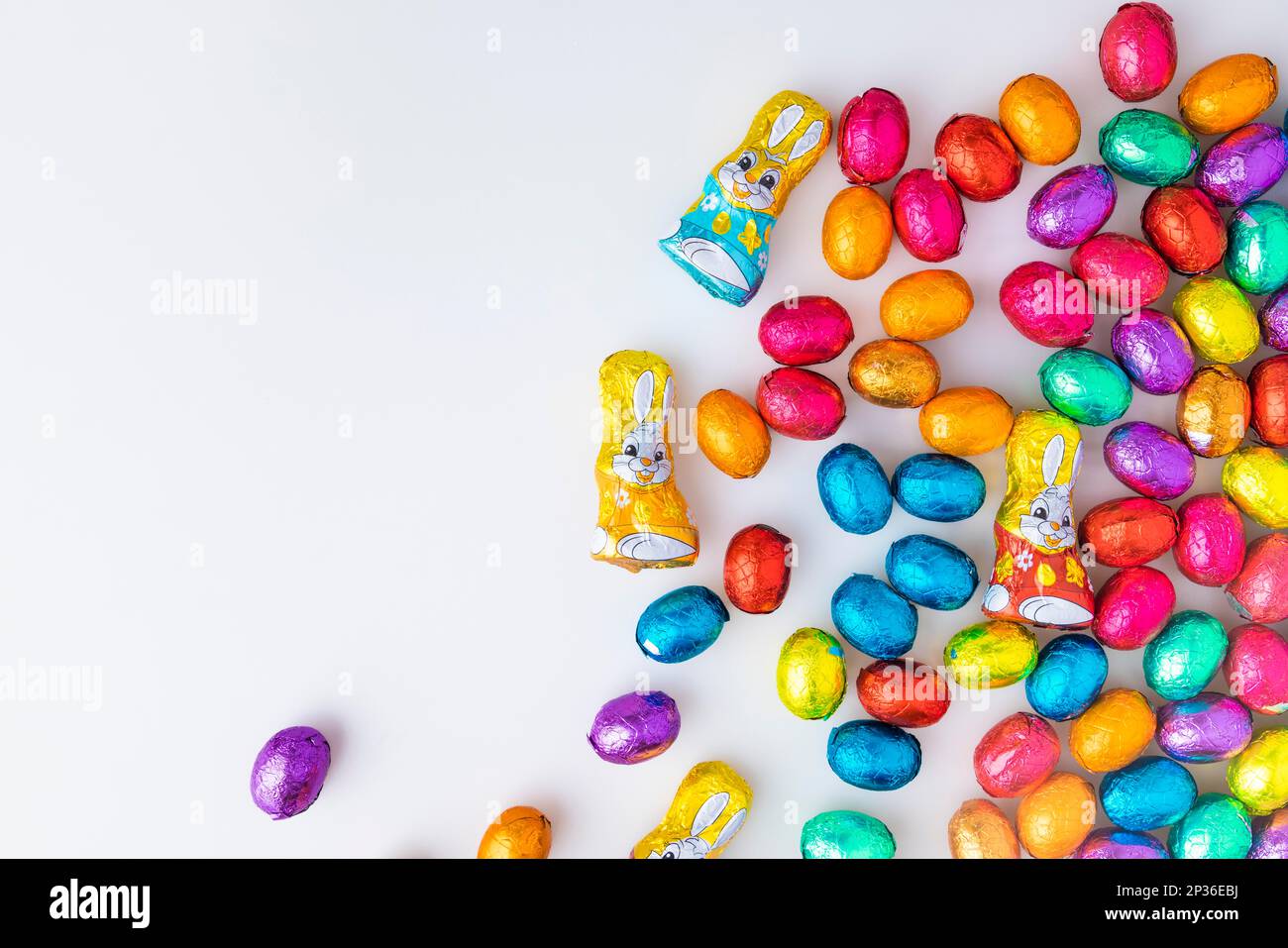 Colourful Easter candy, chocolate bunnies and chocolate eggs on a white ...
