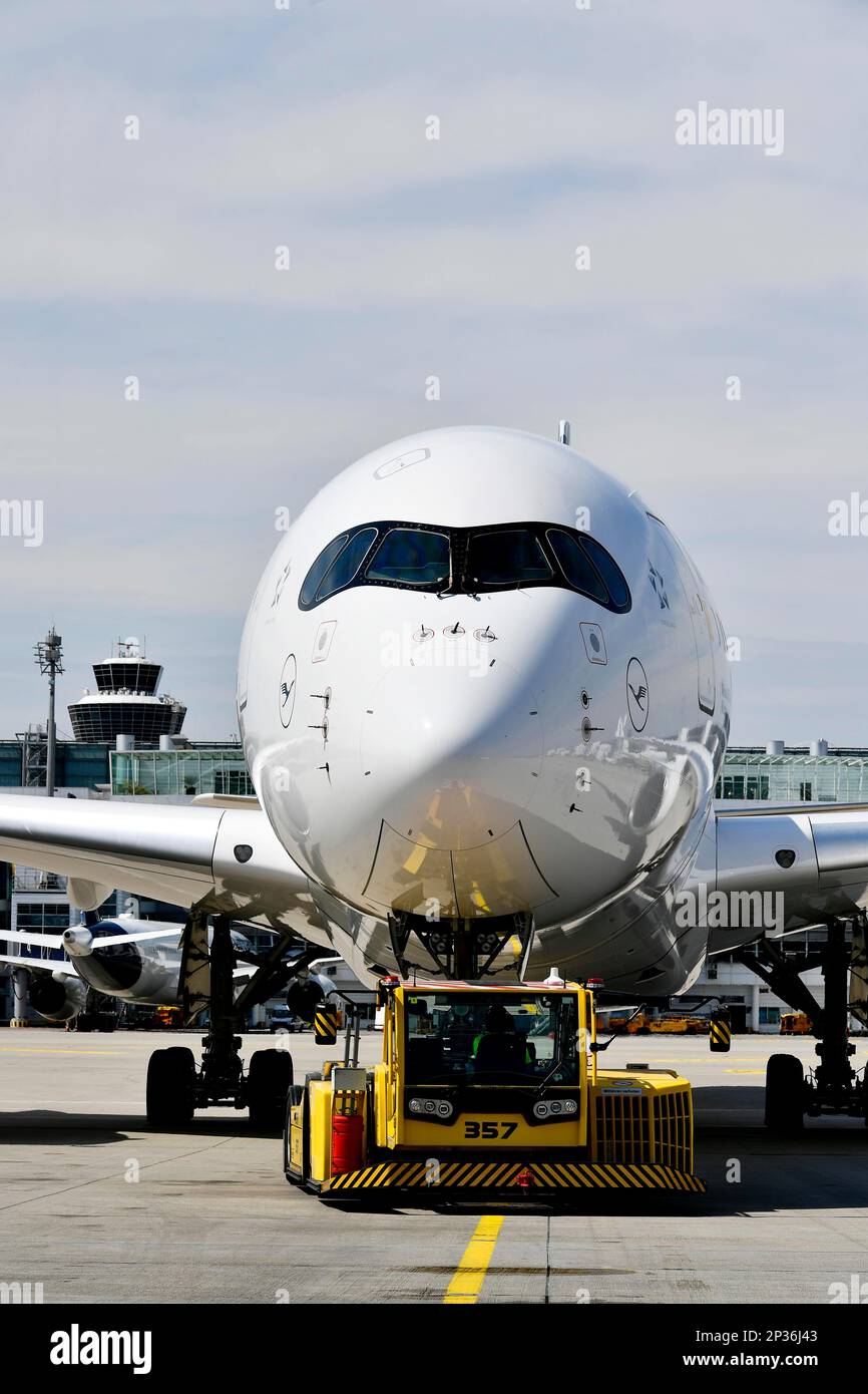 Lufthansa Airbus A350-900 towing with push-back truck in front of ...