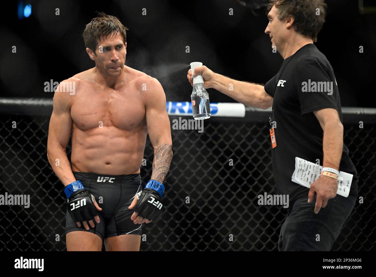 Actor Jake Gyllenhaal, left, is sprayed for the appearance of sweat ...