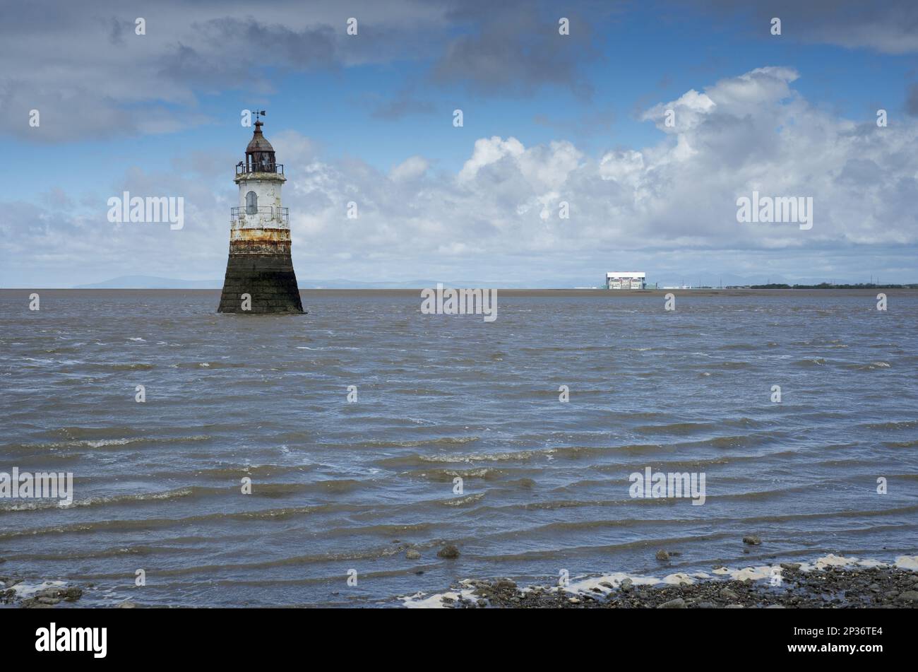 View over estuary with lighthouse, looking towards Furness Peninsula ...