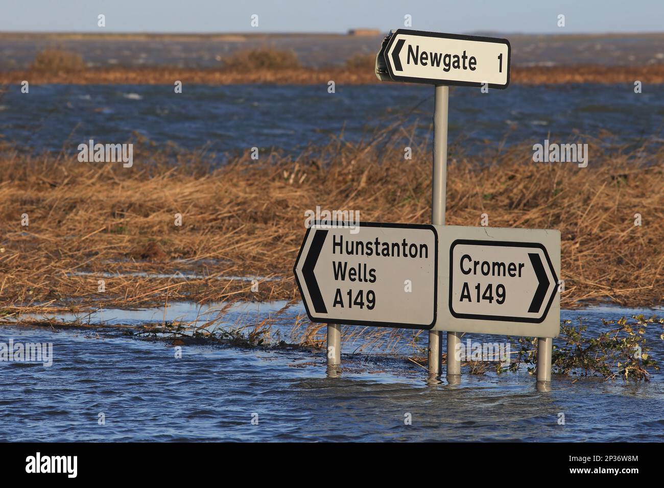 Flooded coastal road and coastal marshes after the tidal surge, Cley ...