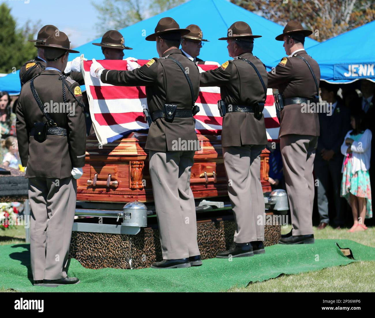 Utah Highway Patrol troopers fold the casket flag at the burial ...