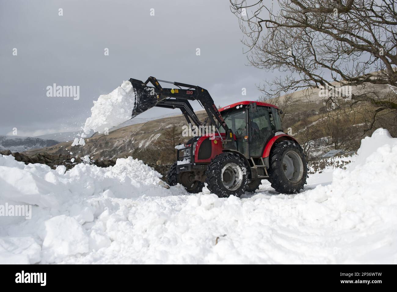 Zetor tractor with loader clears snow from blocked country road after ...