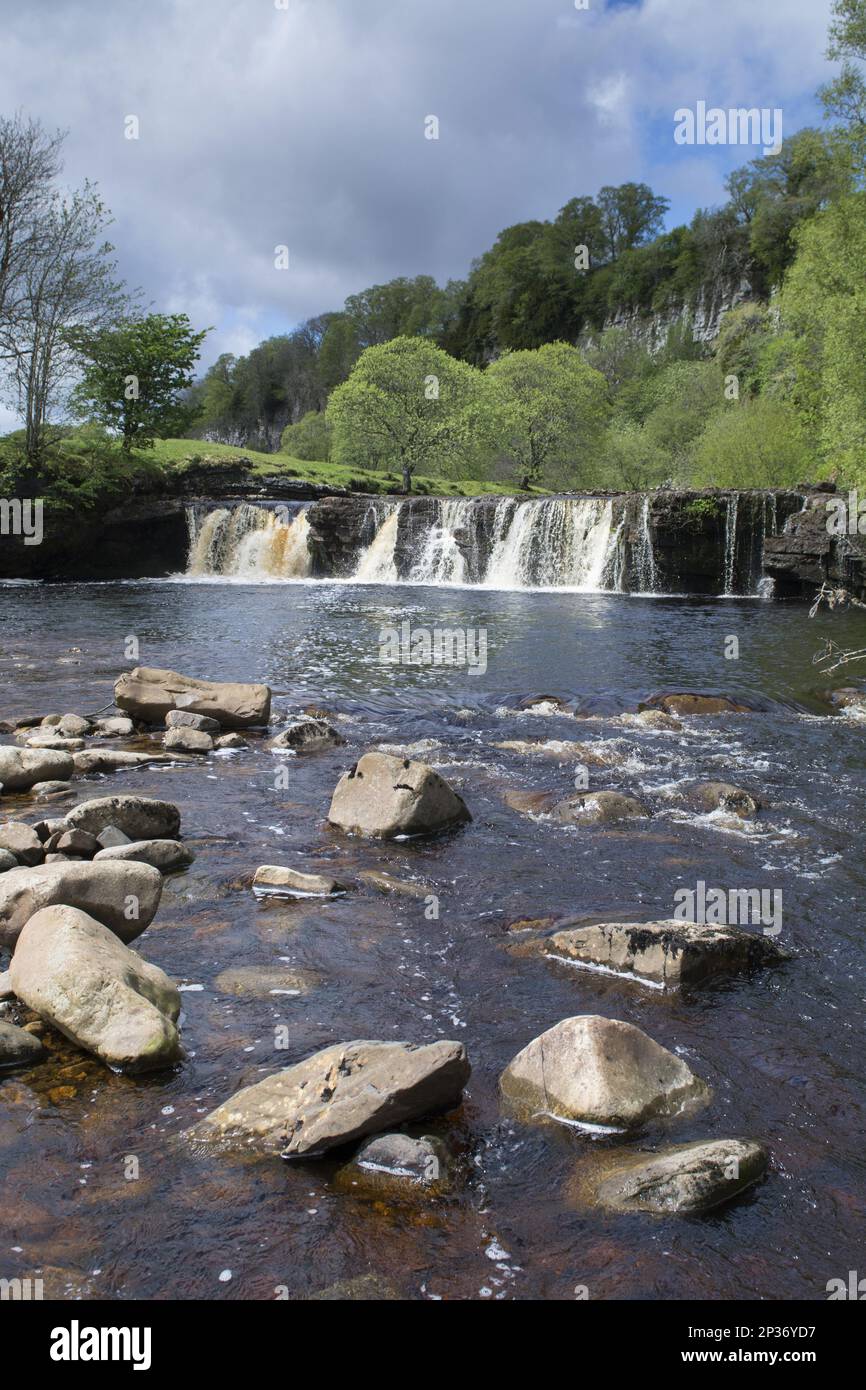 View of river and waterfall below limestone cliffs, Wain Wath Force ...