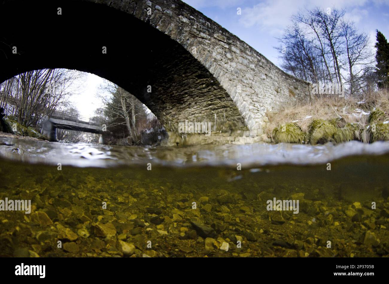 View of the river and bridge from above and below the water surface ...