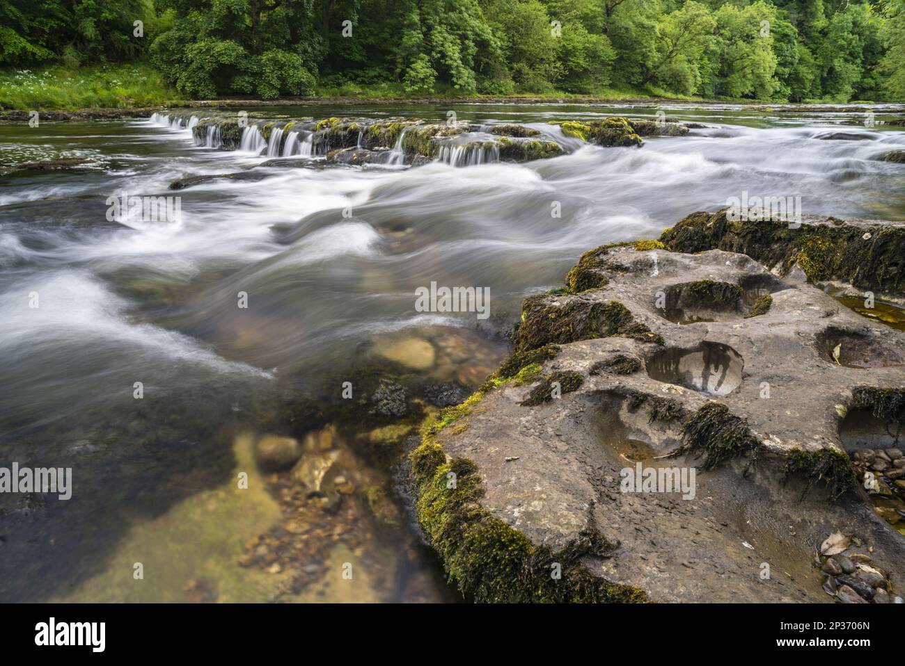 View of eroded rocks beside river and waterfall, Aysgarth Falls, Lower ...