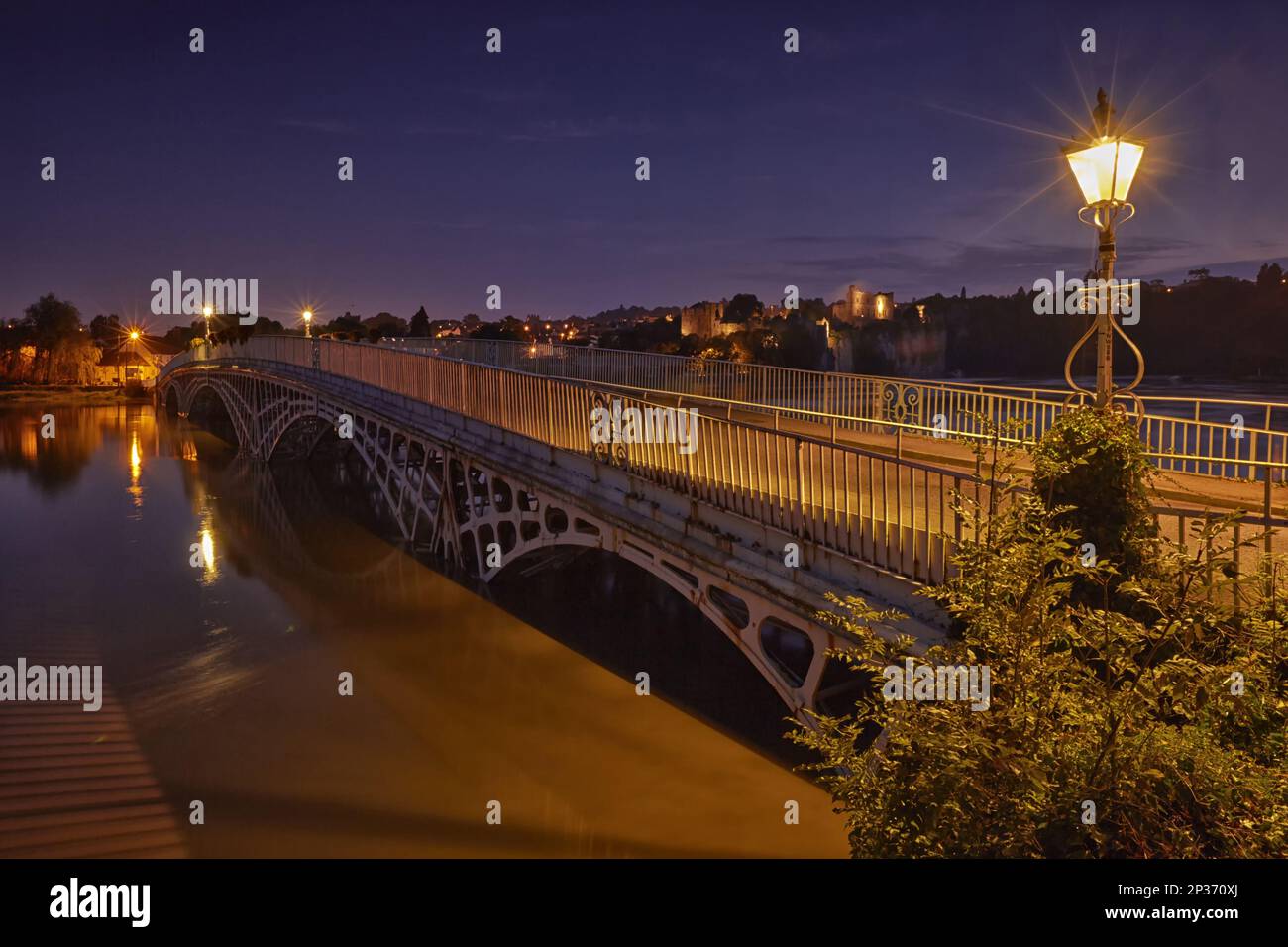 Bridge over the river during the flood at dusk, with Chepstow Castle in ...
