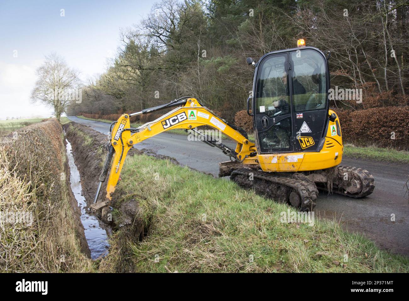 Cleaning overgrown roadside drainage ditches with a JCB excavator ...