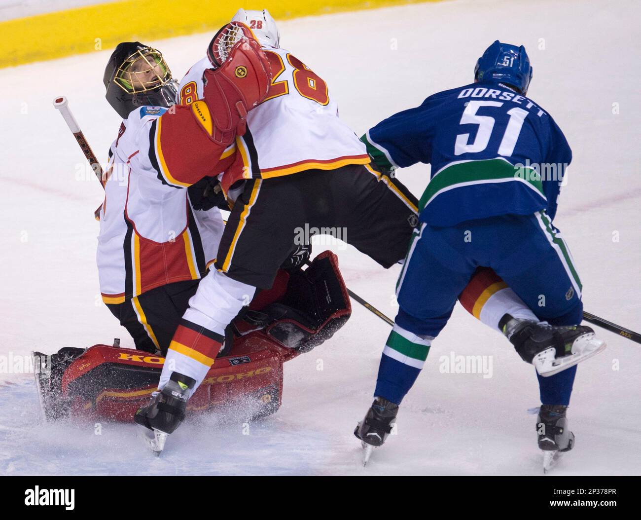 Calgary Flames defenseman Corey Potter (28) bangs into Flames goalie ...
