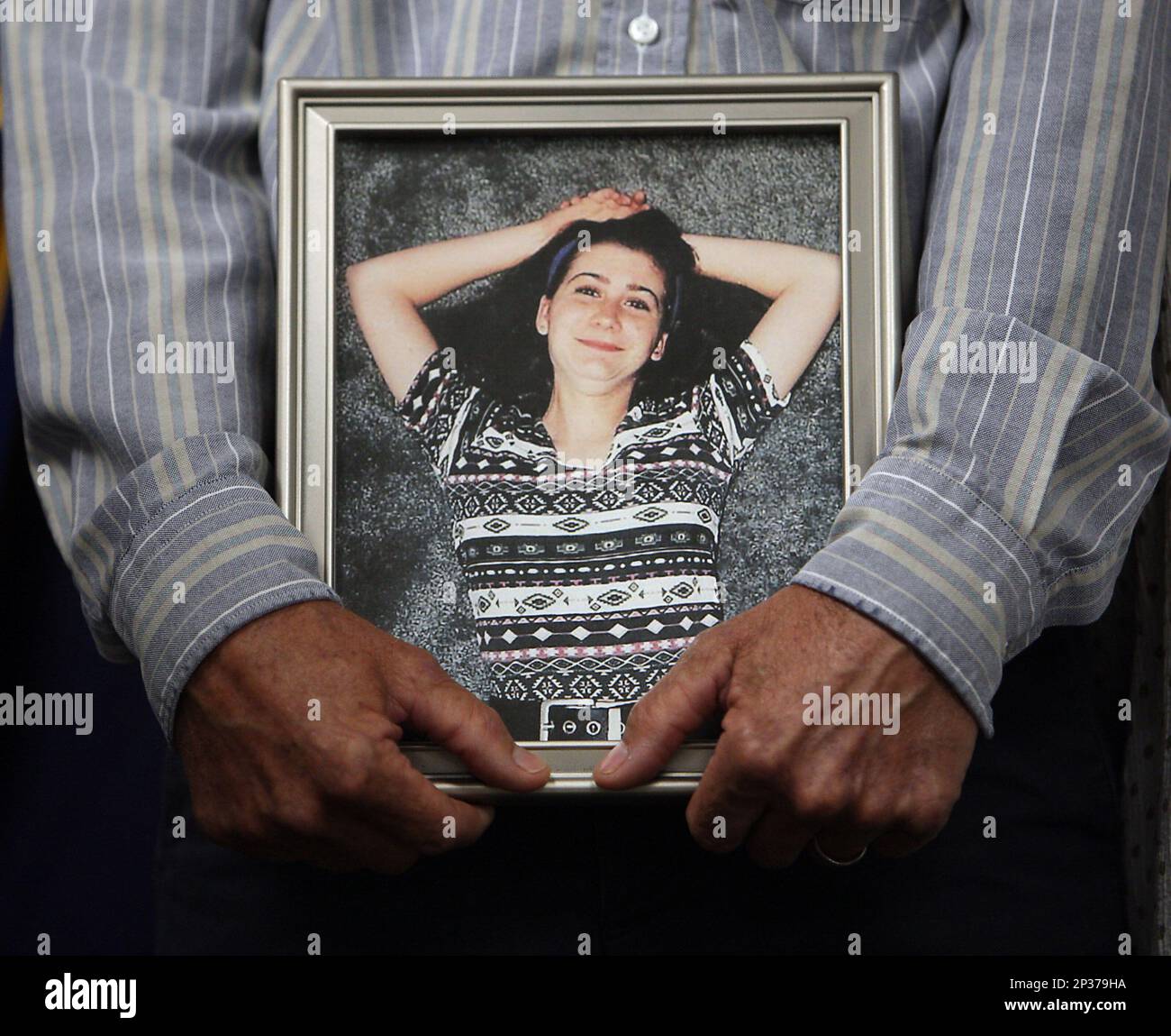 In this Aug. 23, 2013, Robert Majewski holds a photograph of his ...