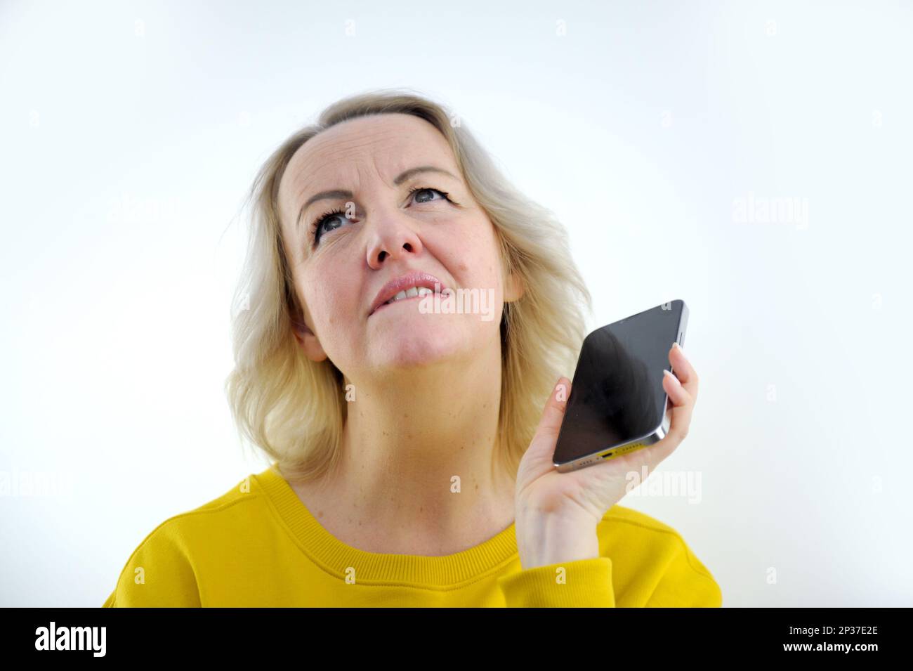 Woman and biting lip and guilty hi-res stock photography and images - Alamy