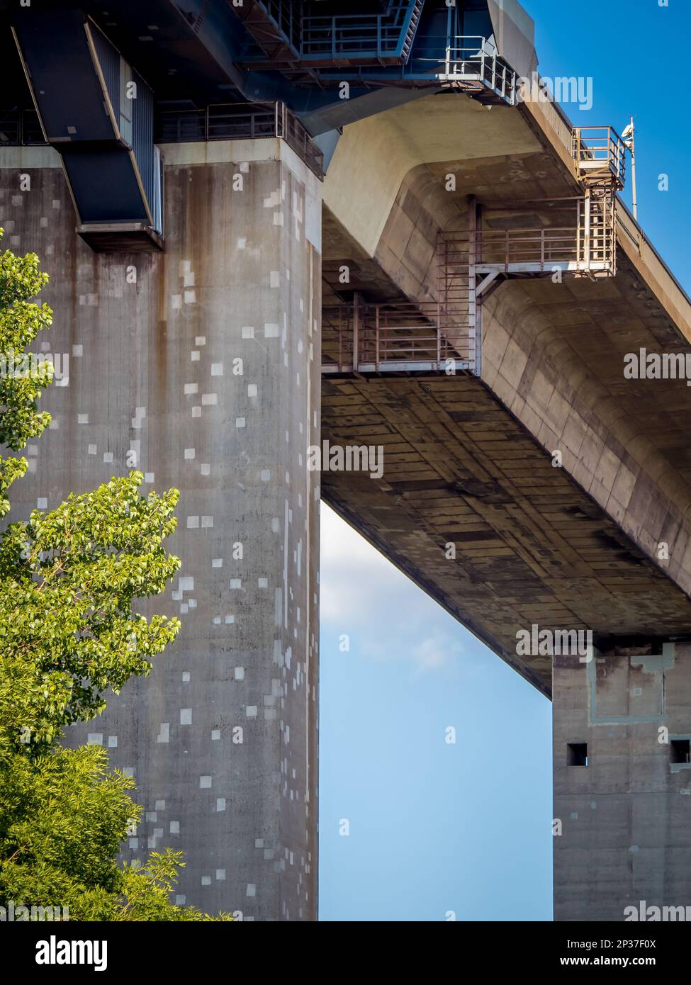 Bottom of decrepit concrete suspension bridge pillars and deck of ...