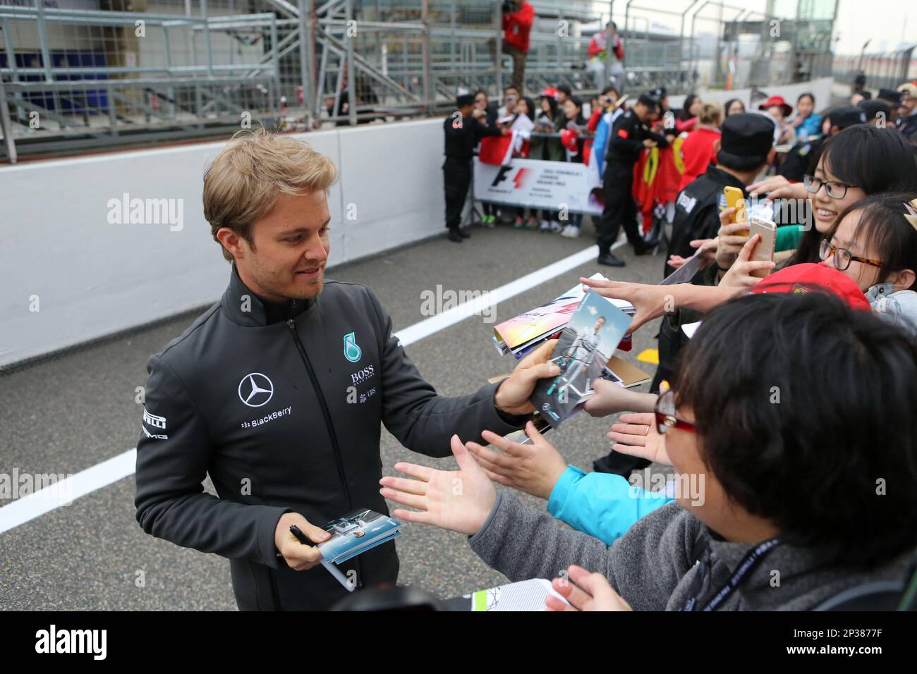 German F1 driver Nico Rosberg of Mercedes signs autographs for fans at ...