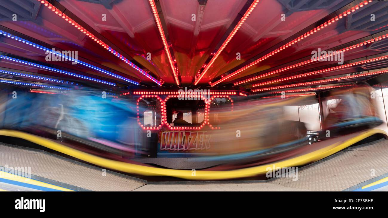 Bright lights of the Waltzer ride of a funfair with a slow shutter ...