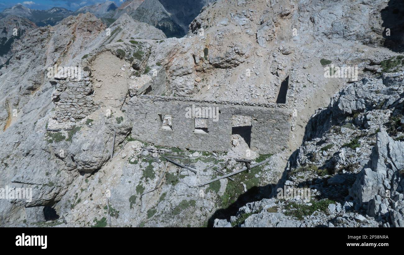 An old, destroyed building standing near the trail in the Dolomites ...