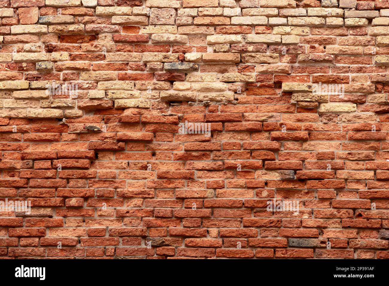 Weathered and sunburned old brick wall. High resolution photo with ...