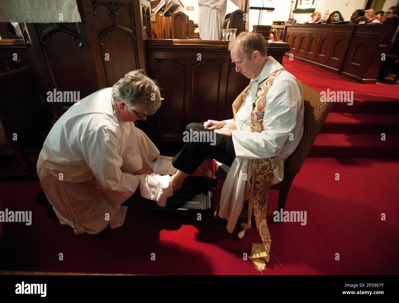Rev. Tom Morris, Assisting Priest, washes Rector Rev. David Luckenbach ...