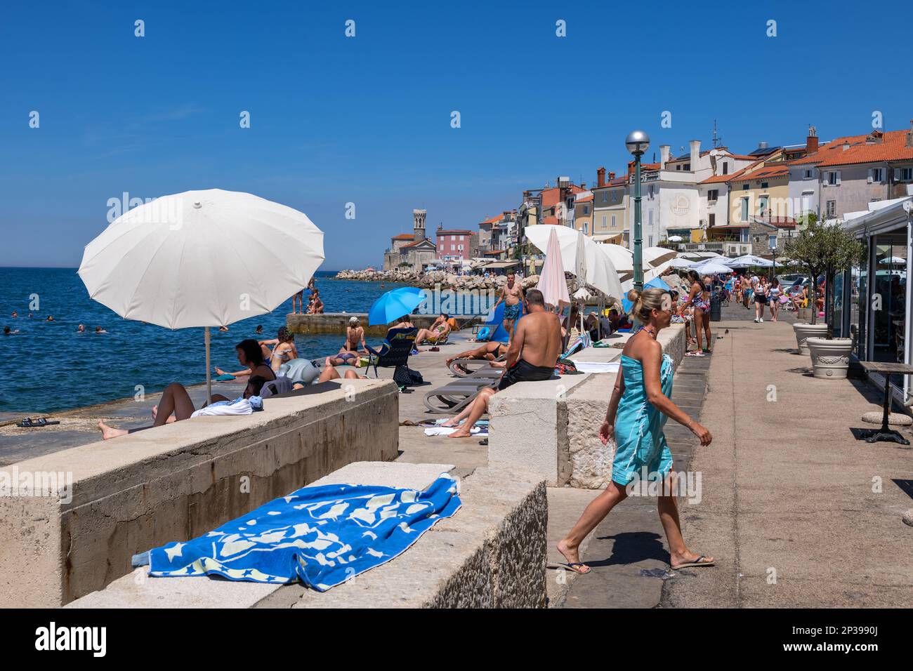 Piran, Slovenia, people relax at seaside waterfront in resort town on ...