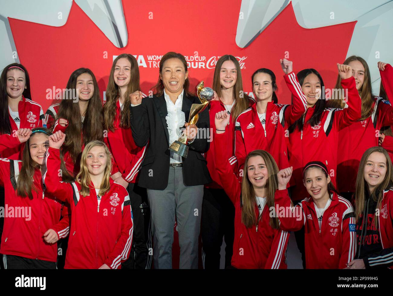 Members of the Nepean Hotspurs soccer team surround Nozomi Yamago, of ...