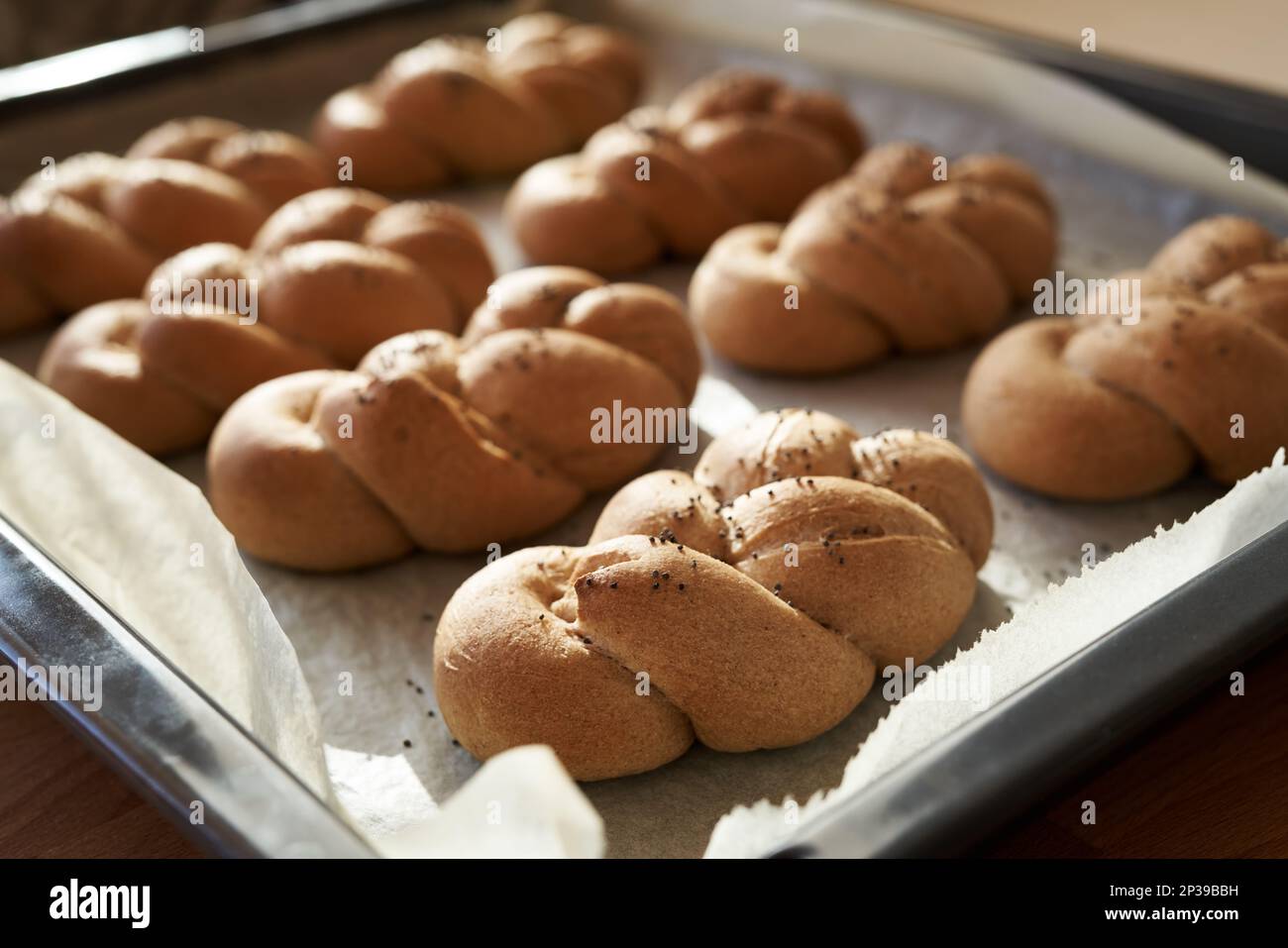 Homemade braided bread buns or rolls made of whole grain spelt flour on ...