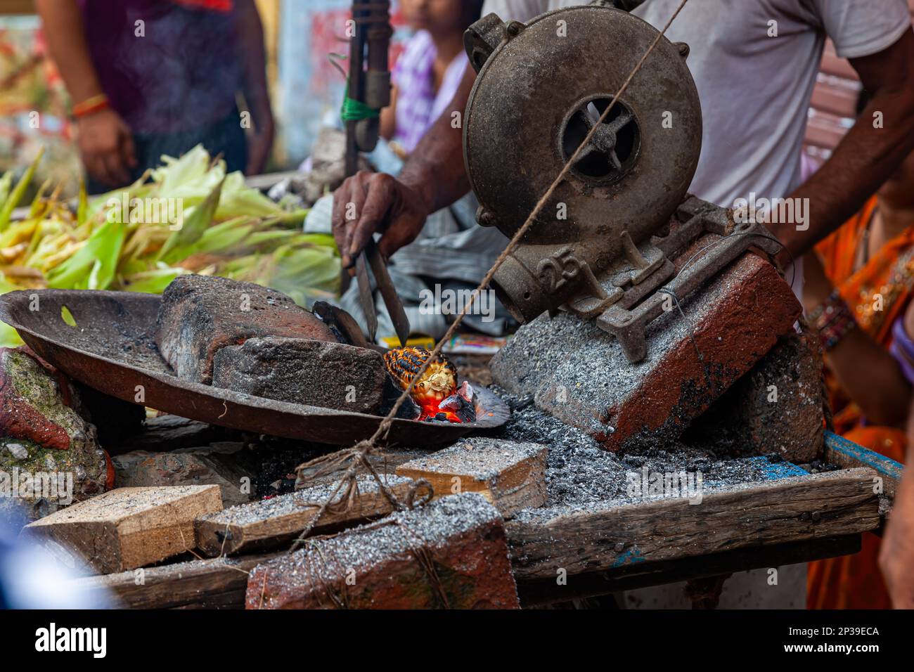 Indian man hands roasting corn, the indian street food at street market ...