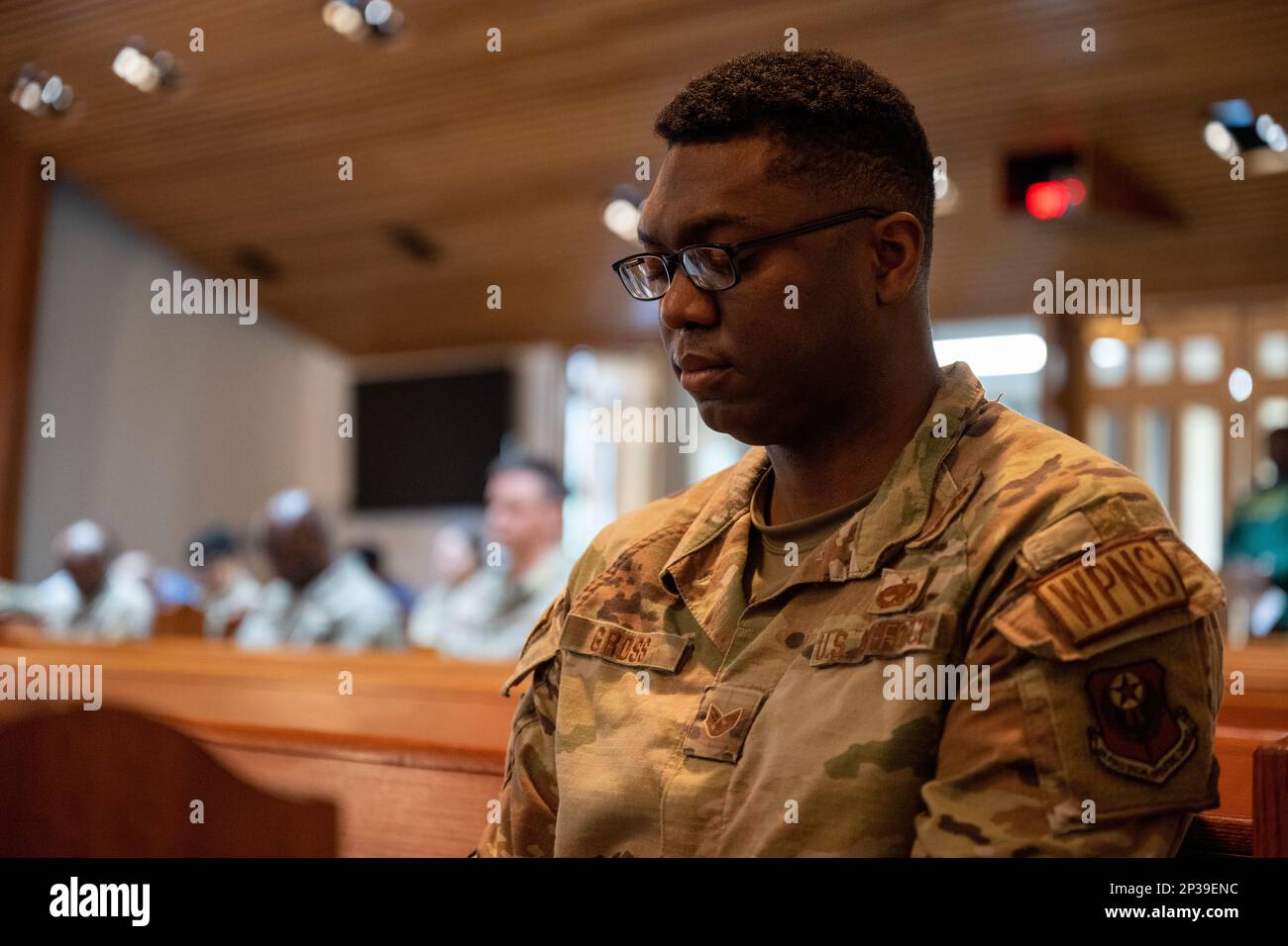 U.S. Air Force Staff Sgt. Harold Gross bows his head to pray during ...