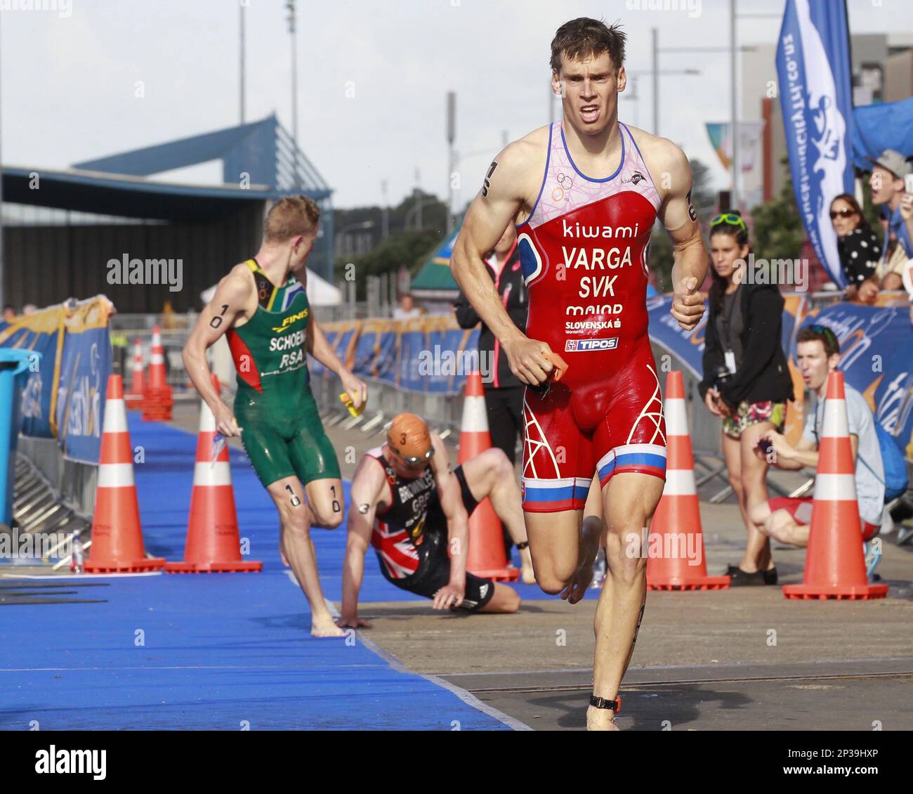 Jonathan Brownlee, center, of Great Britain, falls to the ground ...