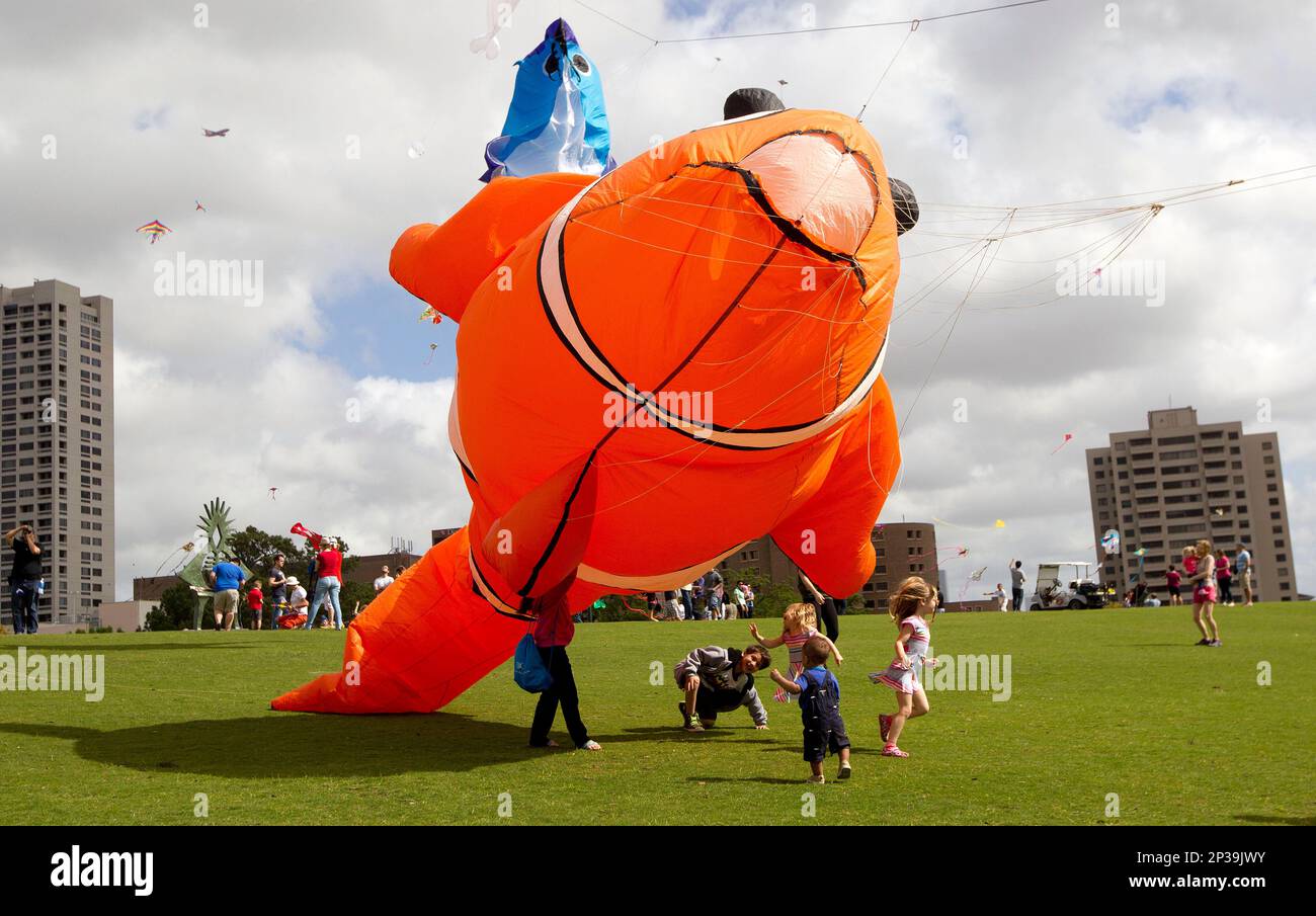 Children play with a large clown fish kite during the Hermann Park Kite ...