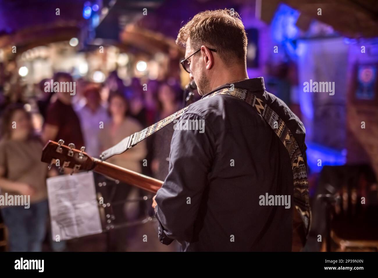 Band performs on stage, rock music concert. Warning - authentic ...