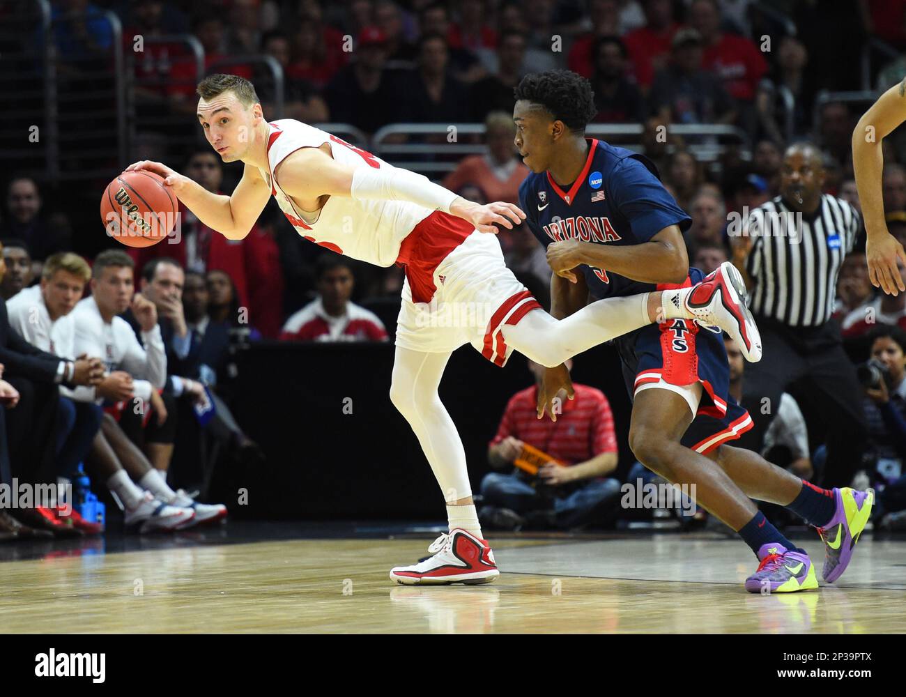 28 March 2015: Guard Josh Gasser (21) of the Wisconsin Badgers loses ...