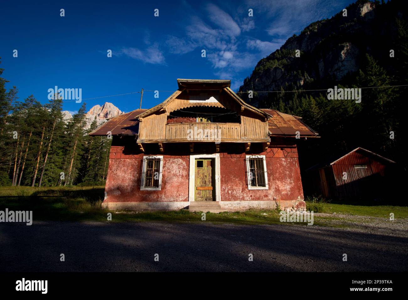 Nice red, abandoned building standing in the Dolomites. Dolomites ...