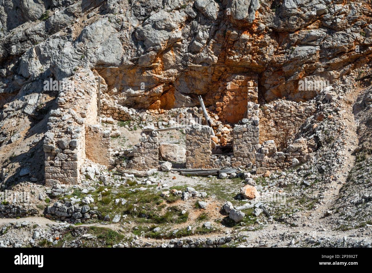 An old, destroyed building standing near the trail in the Dolomites ...