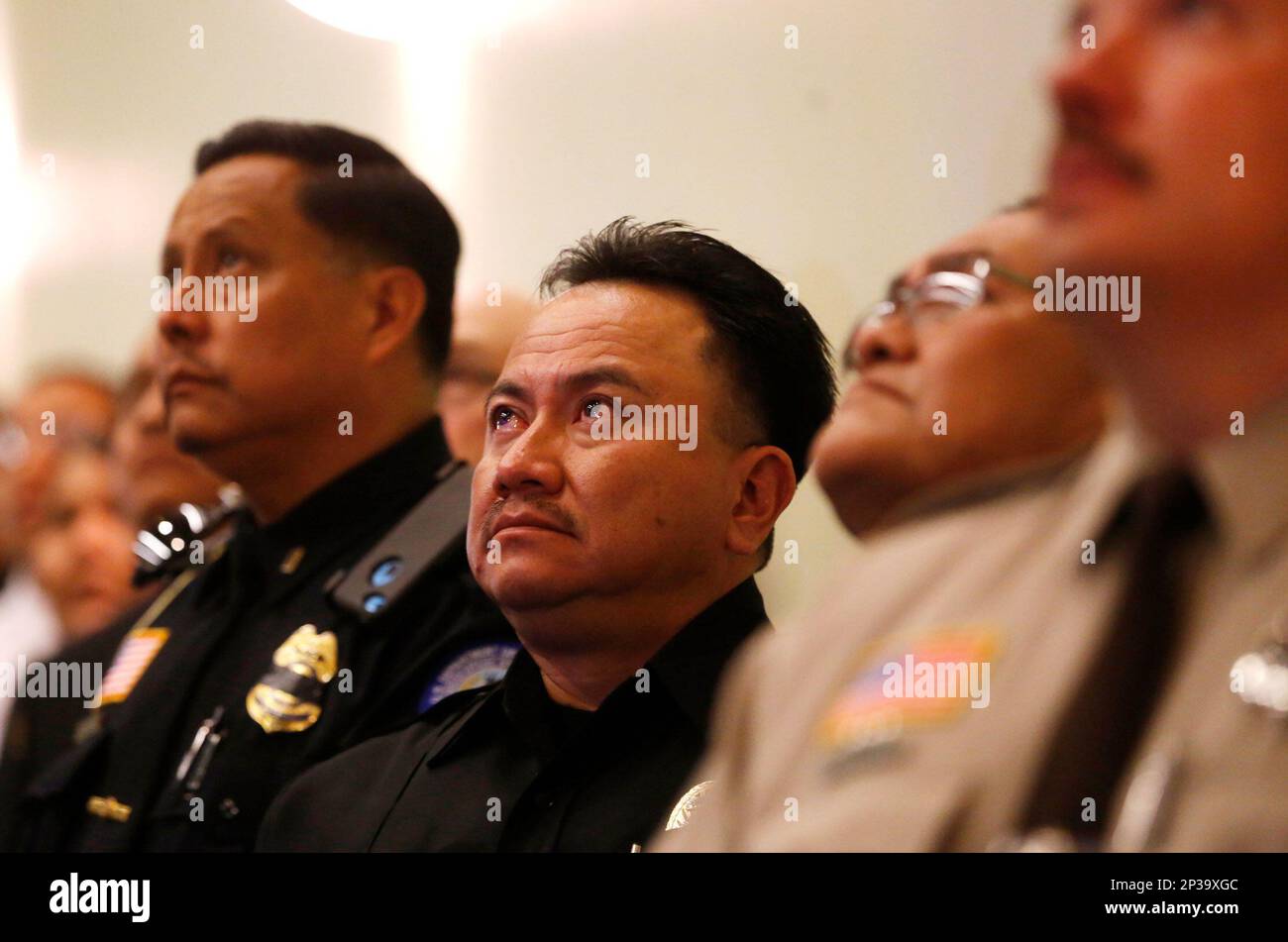 Santa Ana Police Officer Eugene Martinez reacts, Friday, March 27, 2015 ...