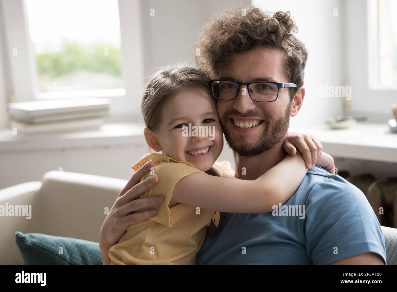 Positive father hugging little kid girl hugging with face touch Stock ...
