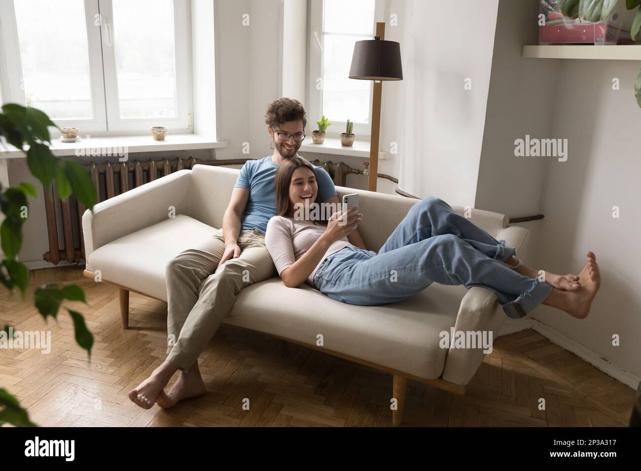 Positive young married couple in love talking on video call Stock Photo ...