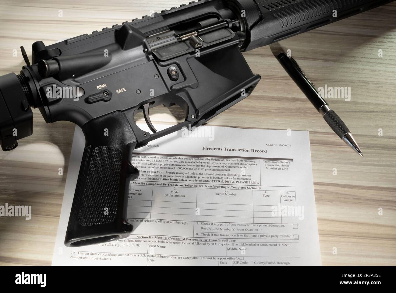 AR-15 on safe with public domain background check form for purchase ...