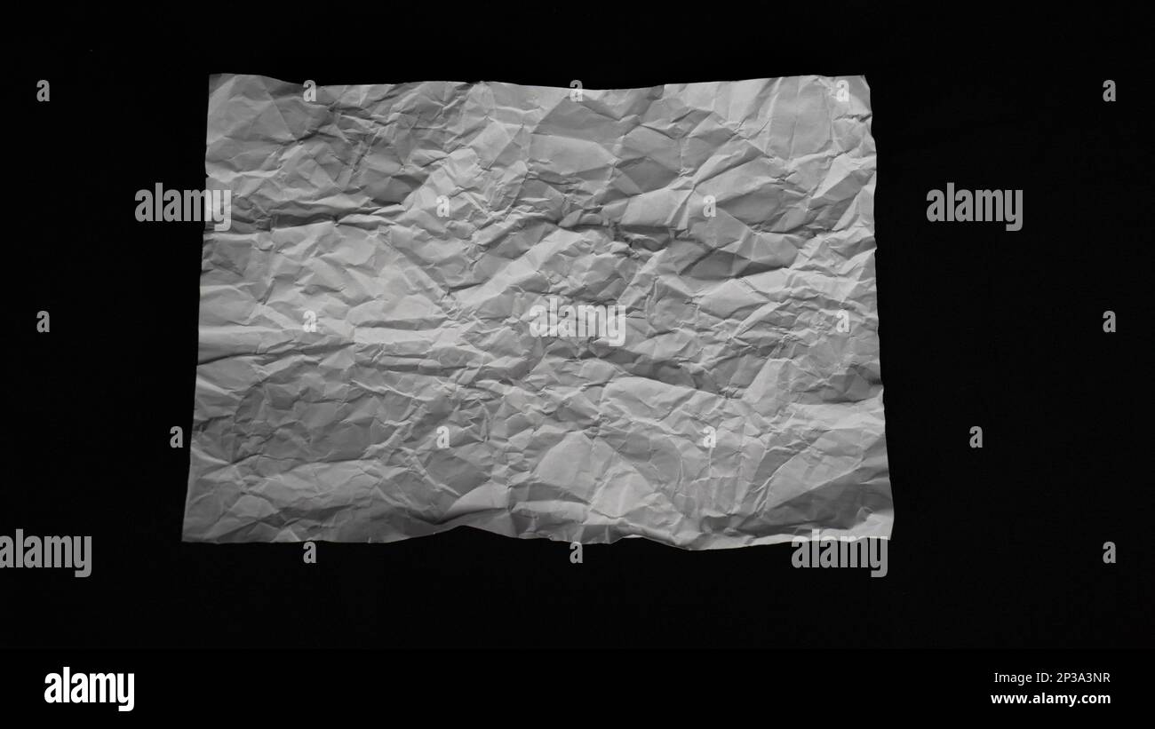 crumpled paper. White and crumpled white a4 paper on black background ...
