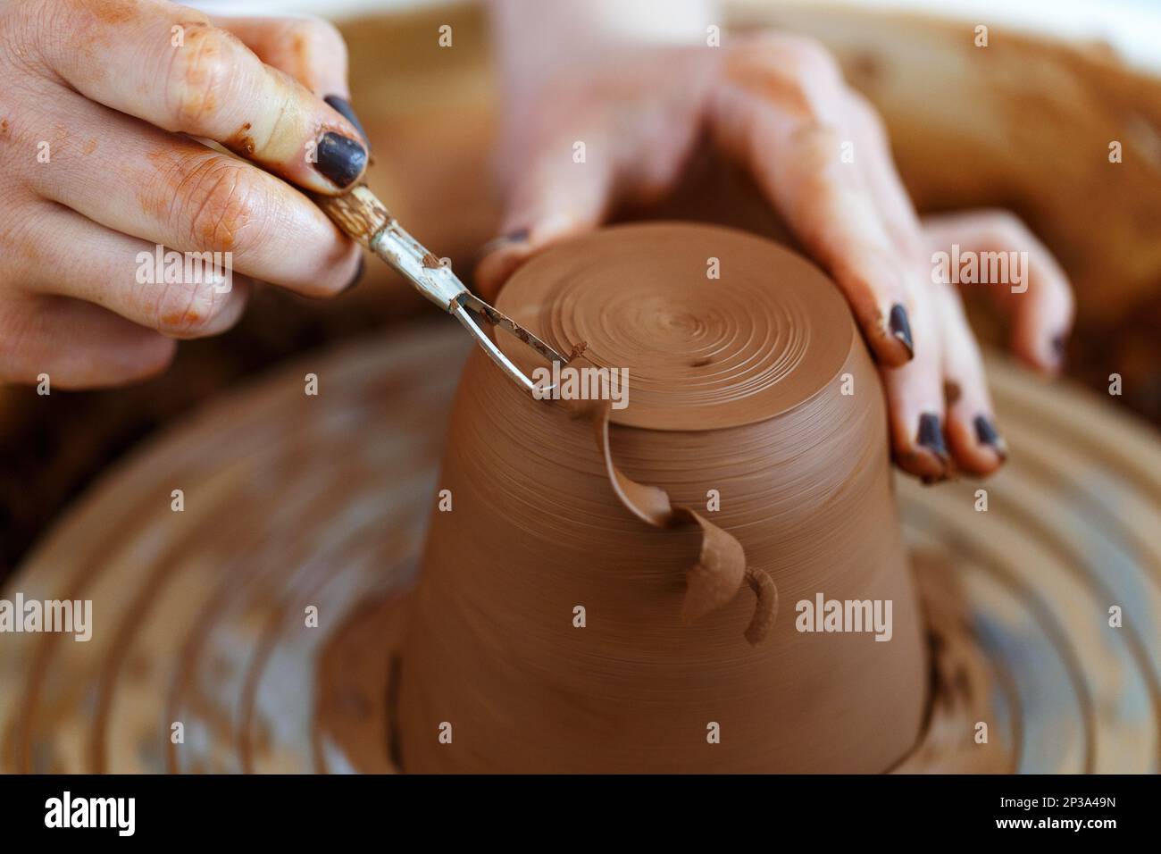 Female hands hold a bowl for casting clay products. Shaped method for ...