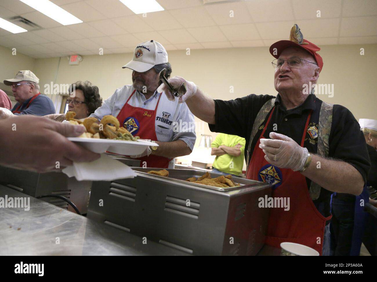 Jim Healy hands out Cajun spiced Alaskan Pollock during the annual fish ...