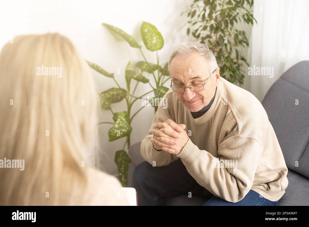 Senior man patient and young woman caregiver medical worker in uniform ...