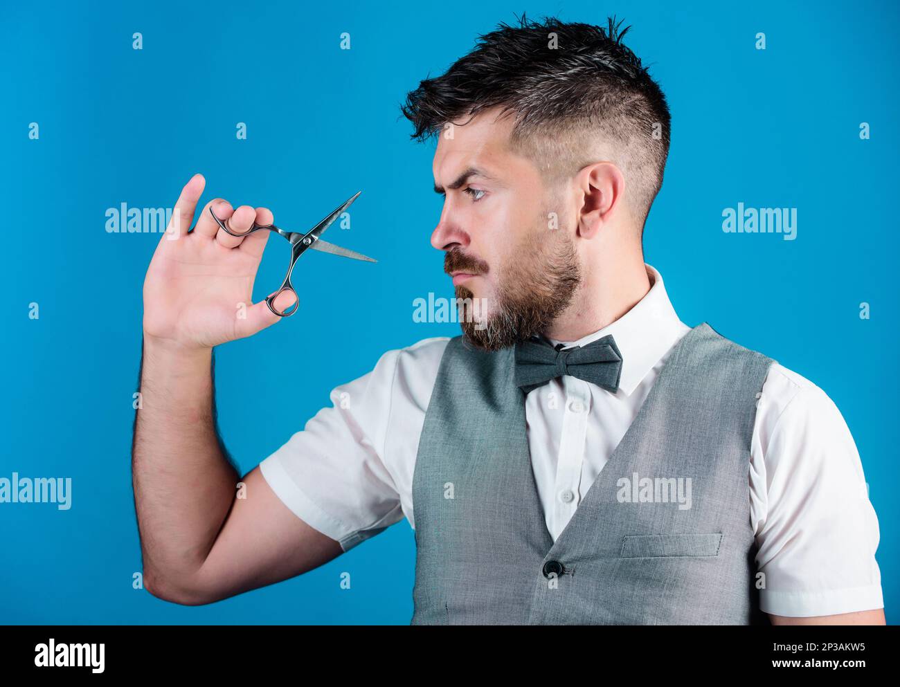 Barber with beard and mustache hold steel scissors. Grooming beard ...