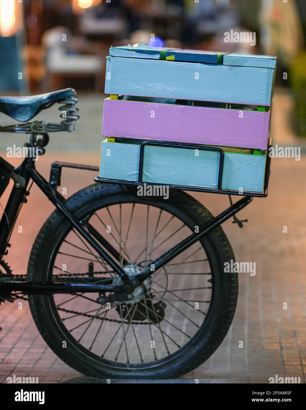 An old bicycle loaded with bright and vibrant colored boxes sitting ...