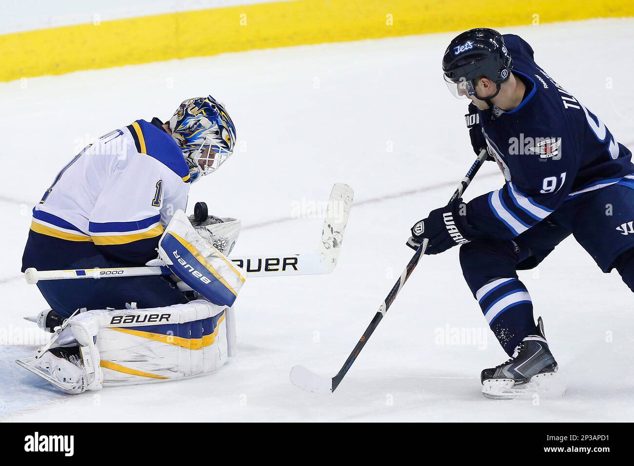 St. Louis Blues goaltender Brian Elliot juggles a shot by Winnipeg Jets ...