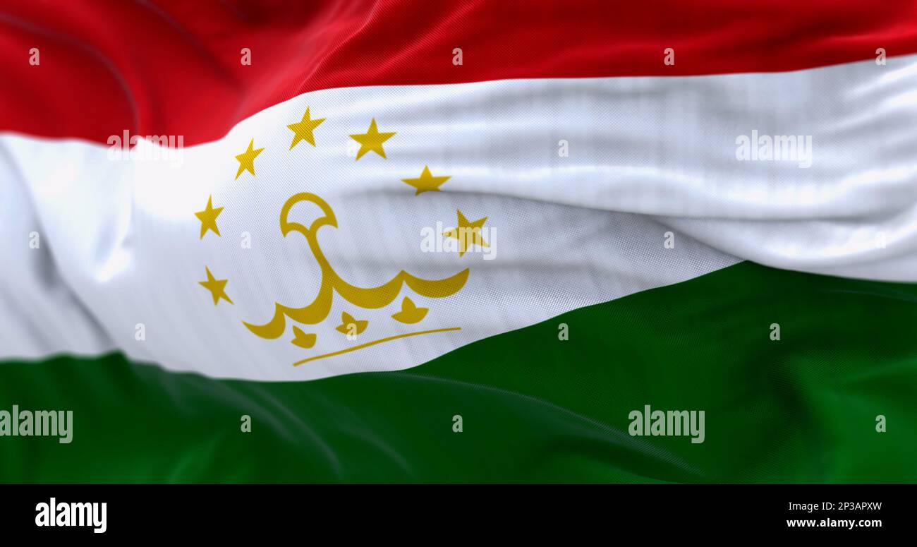 Detail of the Tajikistan national flag waving. Red-white-green stripes ...