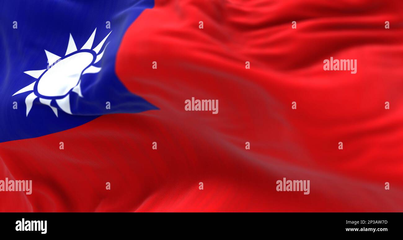 Detail of the Taiwan flag waving. Red flag with white sun with 12 rays ...