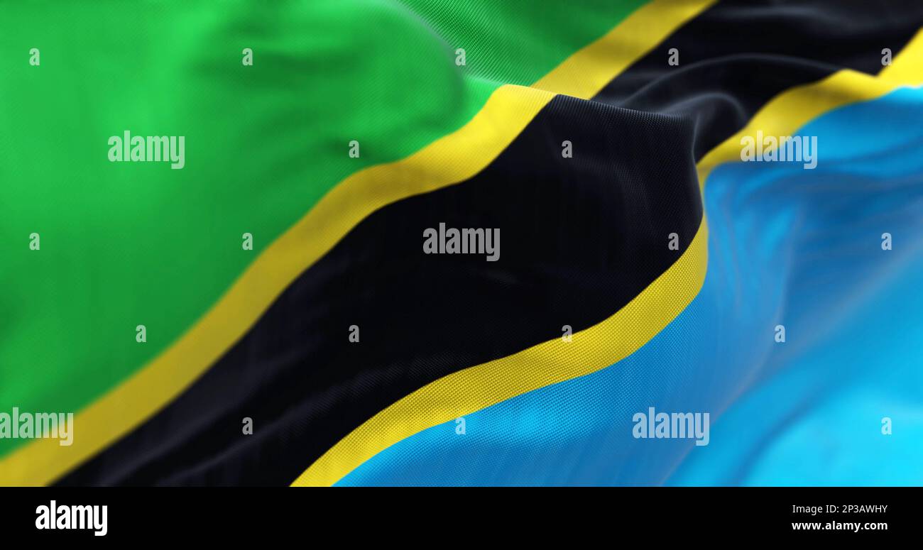 Close-up view of the Tanzania national flag waving. Green and blue ...