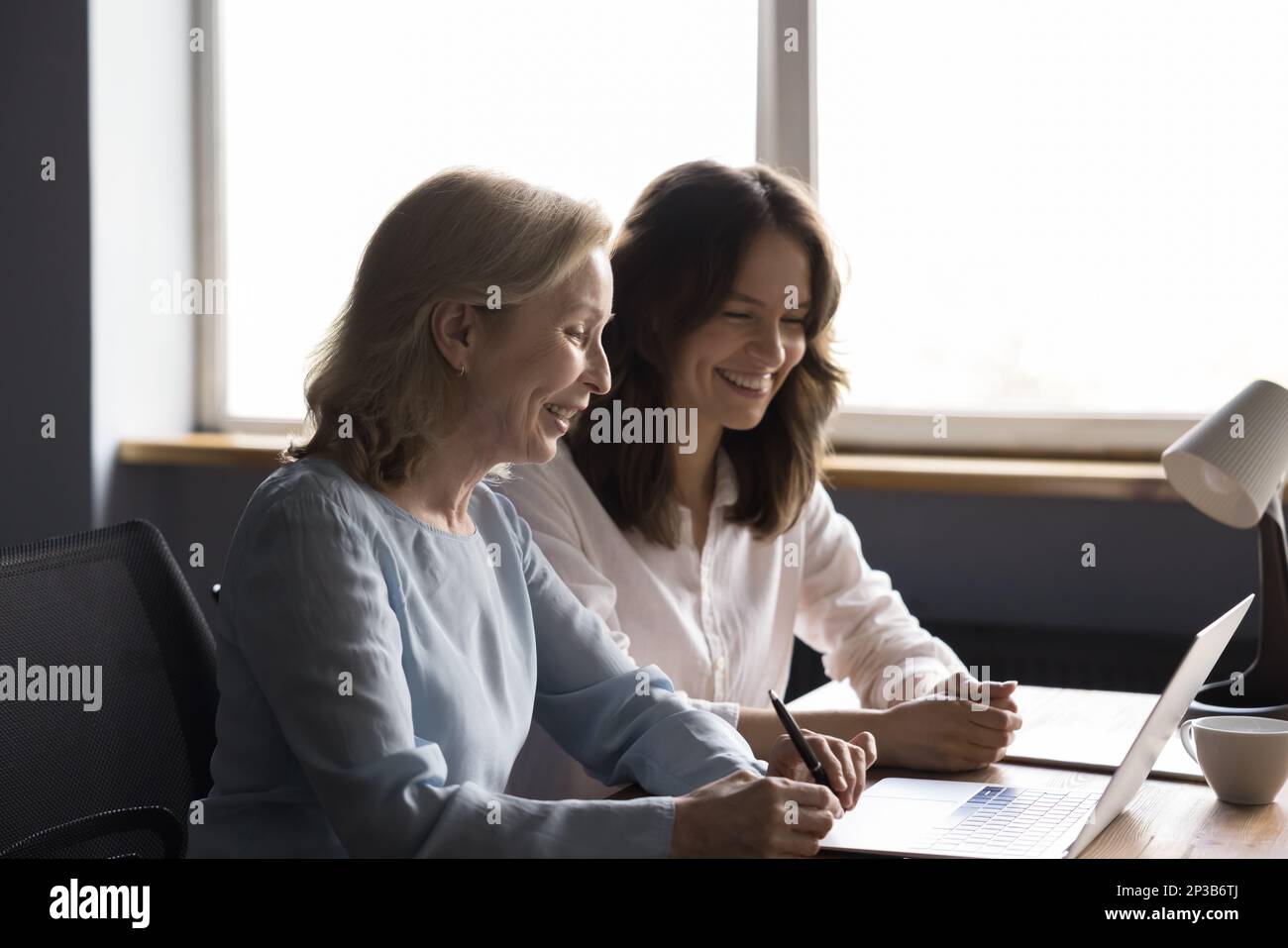Happy cheerful office colleagues women talking at shared laptop Stock ...