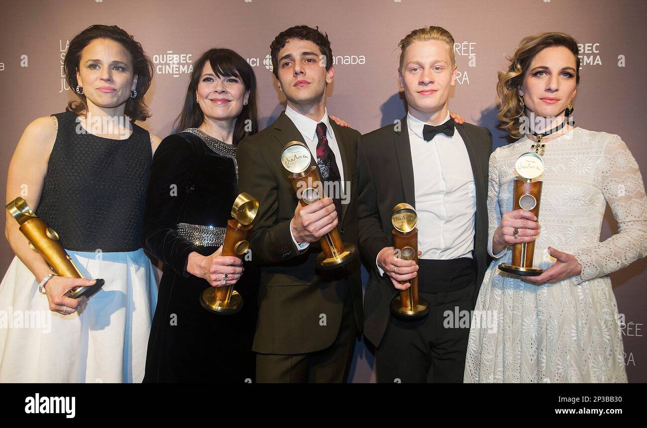 Xavier Dolan, centre, holds up his trophy for best film alongside cast ...
