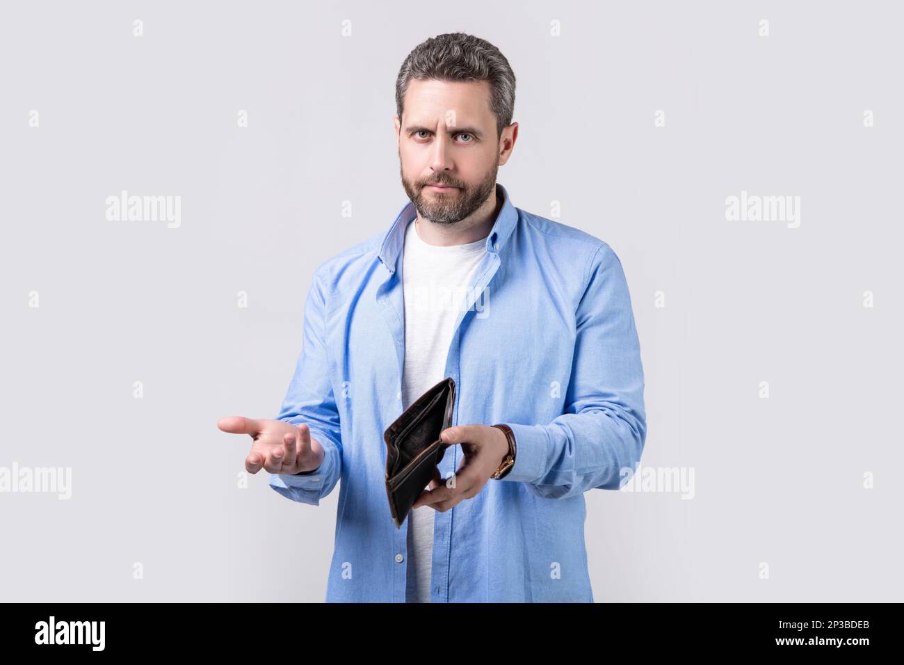 shrugging broke man with wallet isolated on studio background. broke ...